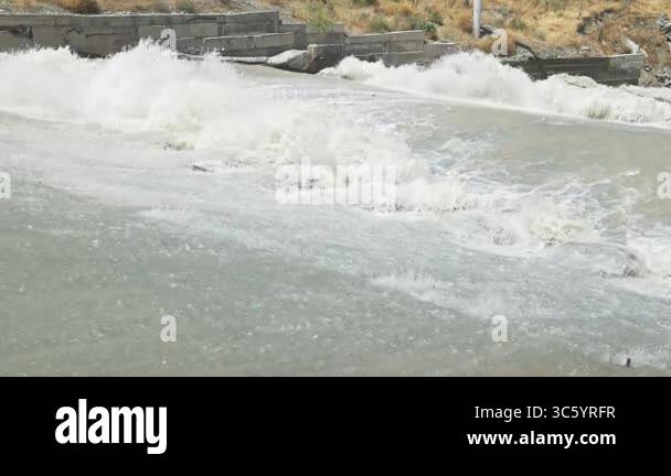row of chute dentate blocks in concrete water spillway channel slope ...