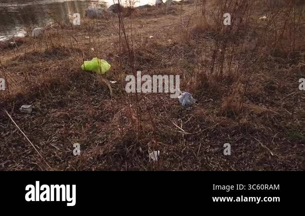 Riverside plastic garbage, trash near city river Stock Video Footage ...