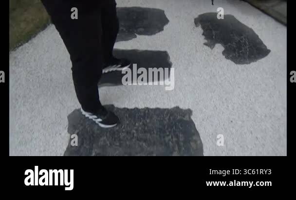 man walking on stone road Stock Video Footage - Alamy