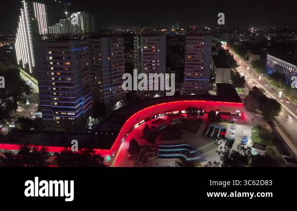 A drone over Tashkent at night, overlooking illuminated streets and ...