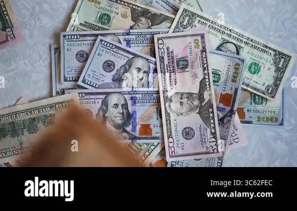 A stack of crisp, dollar bills, held in capable hands. Man counting ...