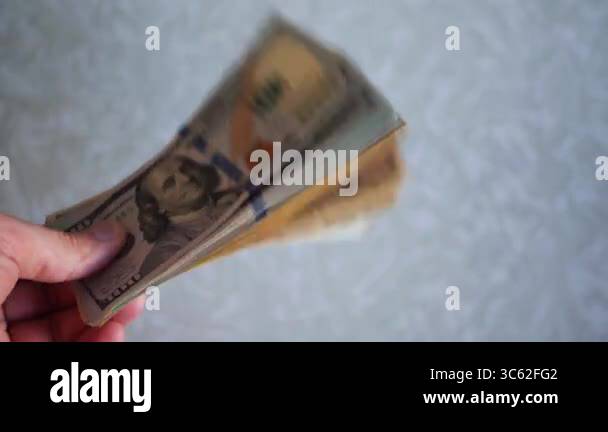 A stack of crisp, dollar bills, held in capable hands. Man counting ...
