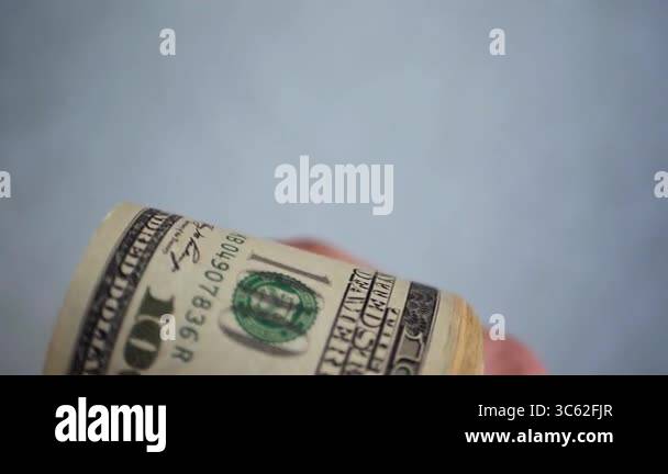 A stack of crisp, dollar bills, held in capable hands. Man counting ...