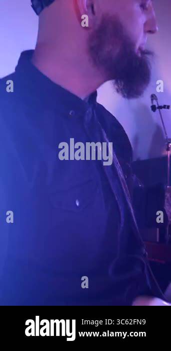Vertical. Rock guitarist plays cool guitar at a rock concert. The guy ...