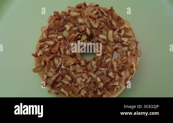 Donut with nut rotating on a pastel green background Stock Video ...
