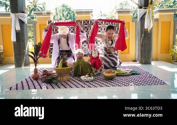 A traditional cultural ceremony featuring two performers in traditional ...
