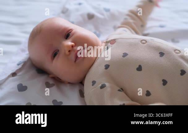 Active newborn playing in a cradle at home, filled with curiosity and ...