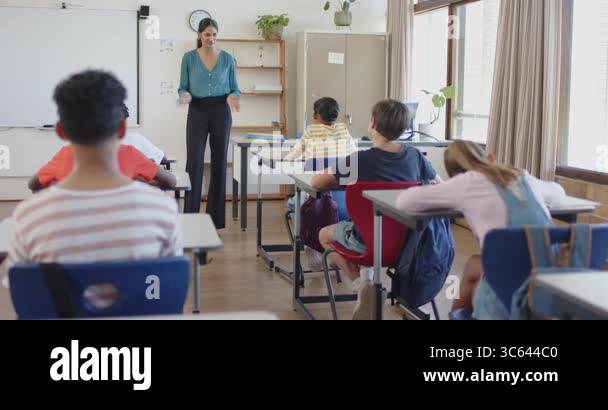 Engaging with students in classroom, teacher fostering interactive ...