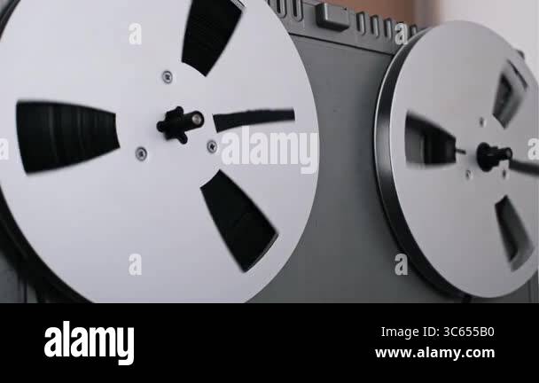 A close-up view of a vintage reel-to-reel tape player, showcasing two ...