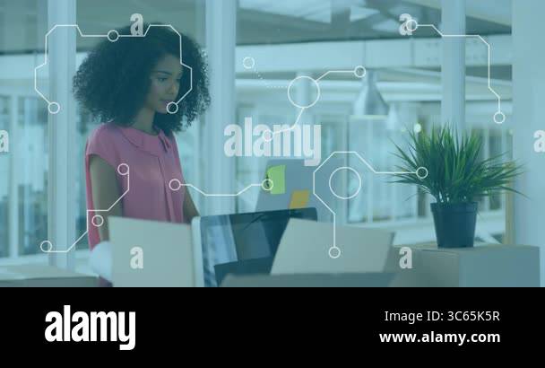 Working at desk, businesswoman using laptop with digital animation ...