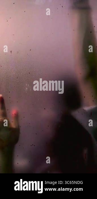 Vertical screen, desperate hand pressing against steamy, translucent ...