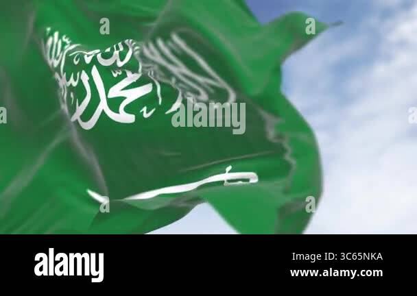 Close- up of the Saudi Arabian national flag waving in the wind. Green ...