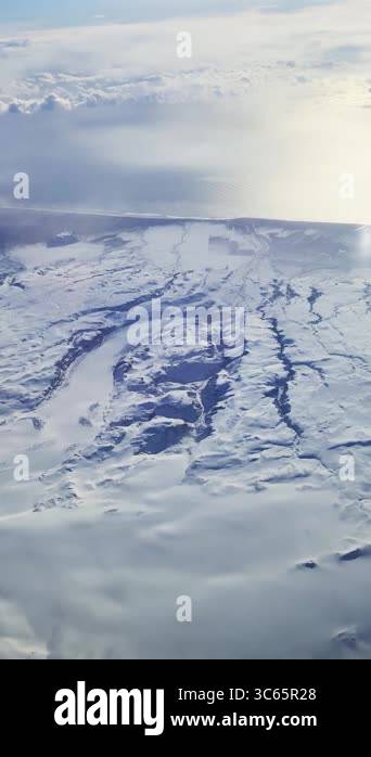 Breathtaking view of a snow covered mountain range seen from above ...
