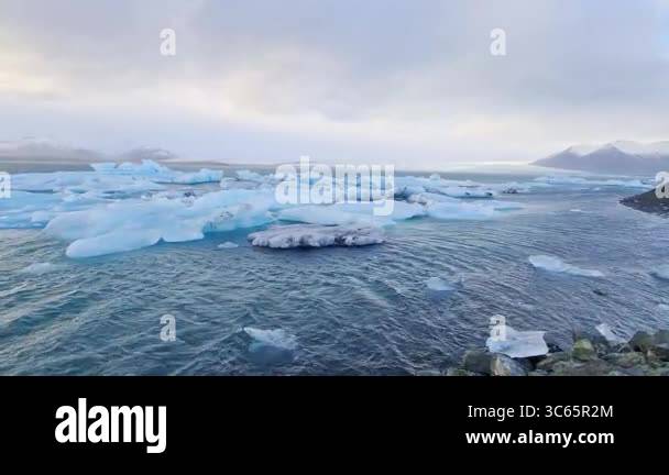 Icebergs float on jokulsarlon glacier lagoon in iceland, demonstrating ...