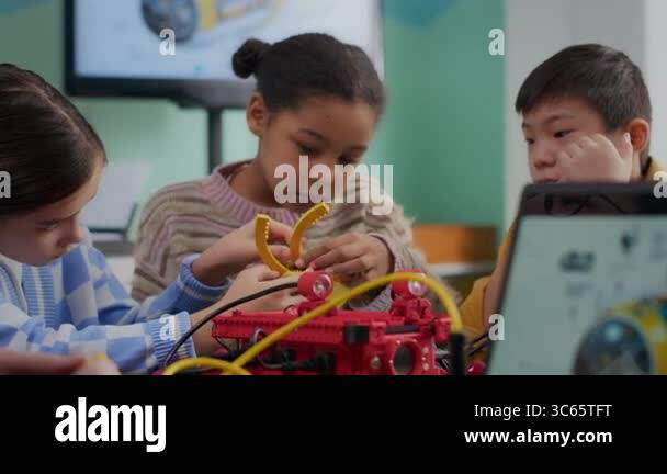 Medium shot of curious diverse kids exploring different parts of robot ...