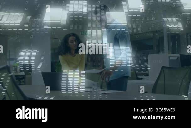 Binary code animation over two people working together at office desk ...