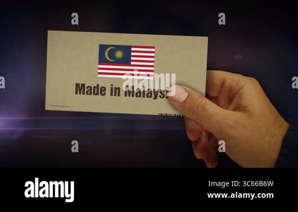 Made in Malaysia box in hands. Malaysian export import Cardboard pack ...