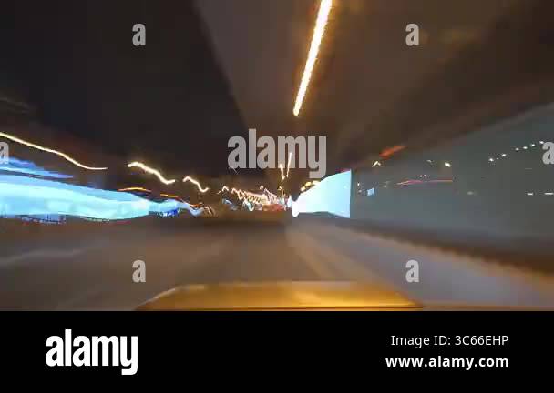 Colorful traffic lights and vehicle look like high speed driving in ...