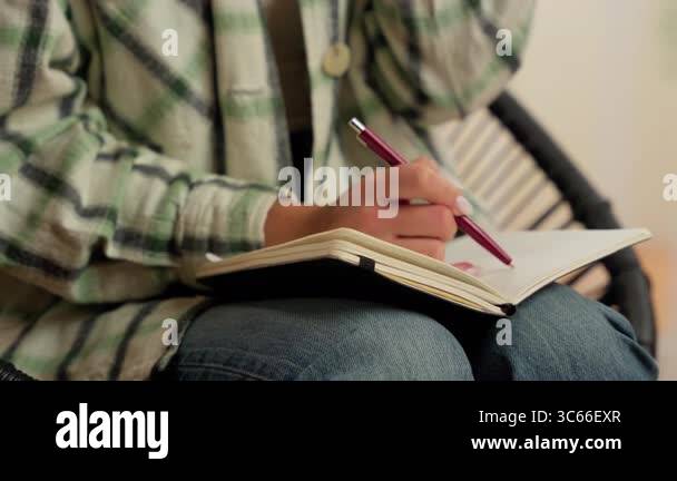 Close up sad Asian Korean woman writing notes in notebook diary ...