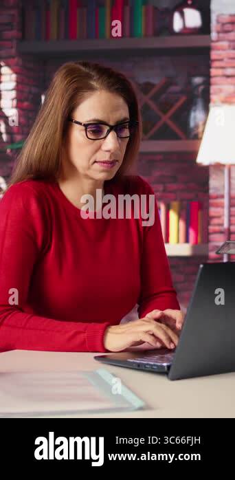 Vertical Video Stressed woman at home desk battling job burnout and ...