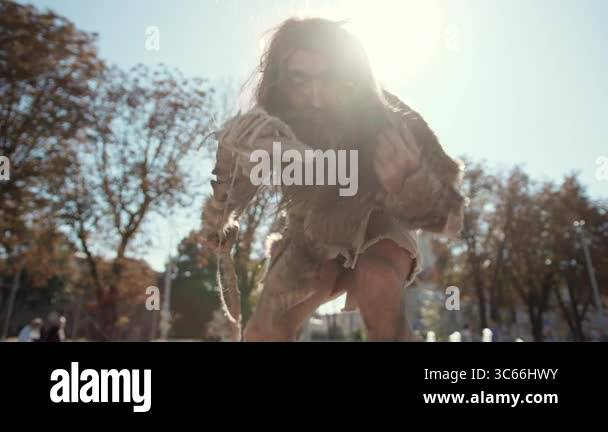 A detailed caveman in a vibrant natural environment, embodying primal ...