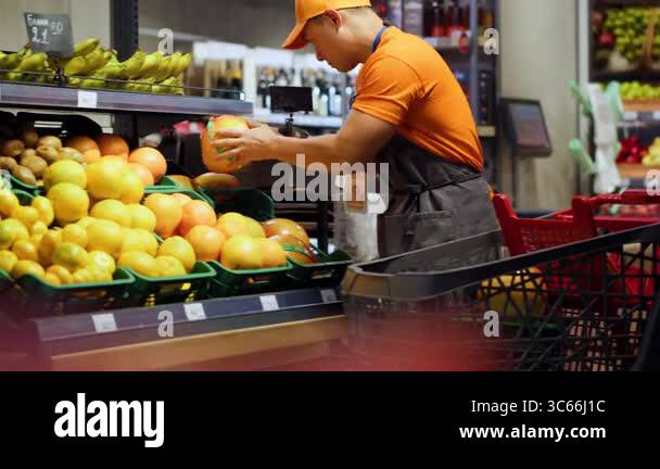 Chinese adult workman wearing uniform arranging fruit vegetables in ...