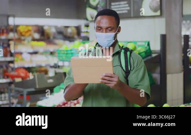 African american guy coureir with delivery bag using tablet pc computer ...