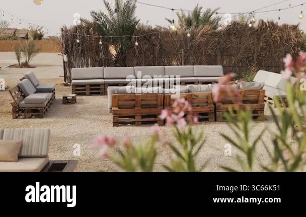 Outdoor lounge in a palm oasis. Video. A cozy outdoor seating area ...