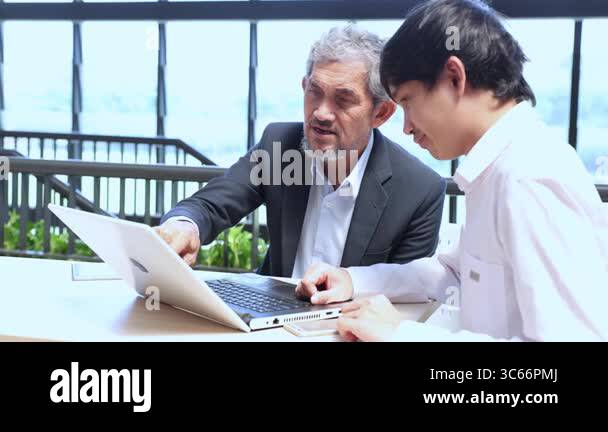 Asian senior professor is giving advice to the college student on the ...