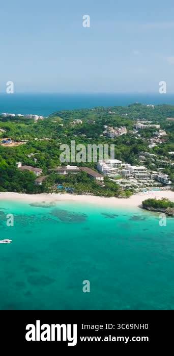 Beach resorts with white sands and tourist boat running over ...