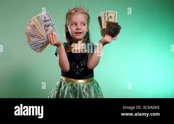 A young princess, radiating joy, displays a fan of money. Emerald-hued ...