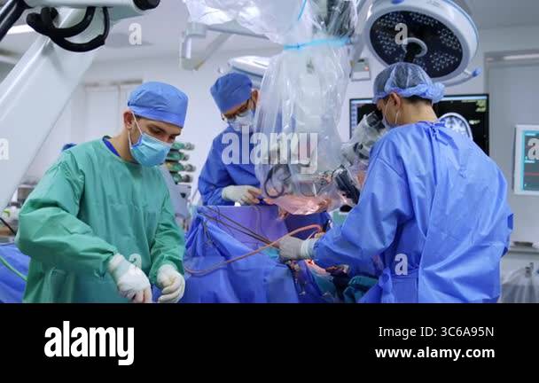 Neurosurgical team performing surgery on brain. Doctors look at ...