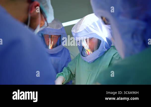 Team of professional male doctors equipped with protective helmets ...