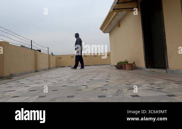 Man in Distress on Marble Rooftop Cloudy Day Neat Flower Pots Urban ...