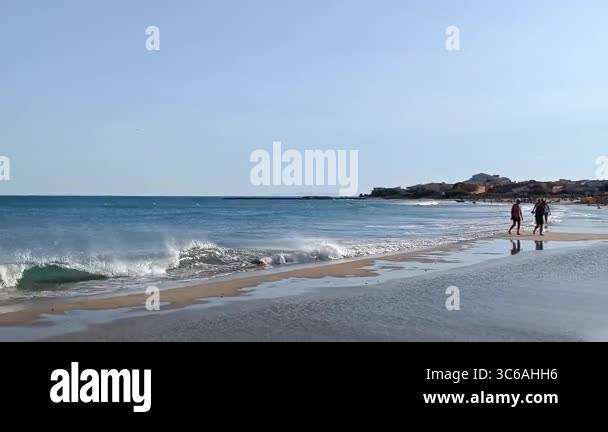 Cap d'Agde beach with several people on the beach and in the water ...