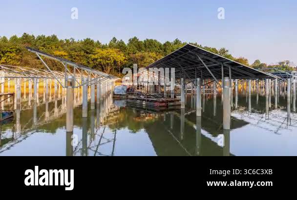 time lapse of the busy photovoltaic construction site at dusk, solar ...