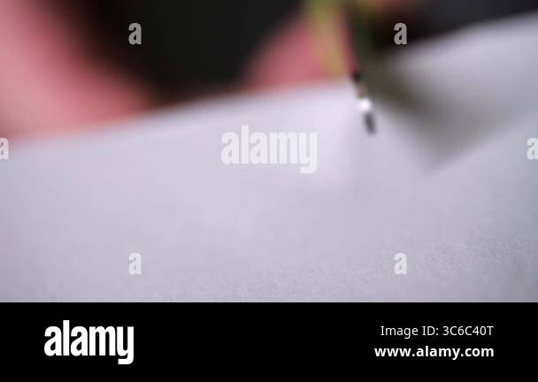 Close up of scissors cutting paper. 4K resolution macro shot. Shallow ...