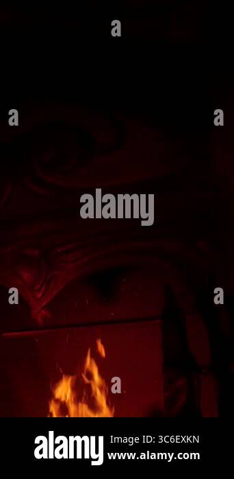 Vertical. Intricate, ornate old fireplace, flames dancing through ...