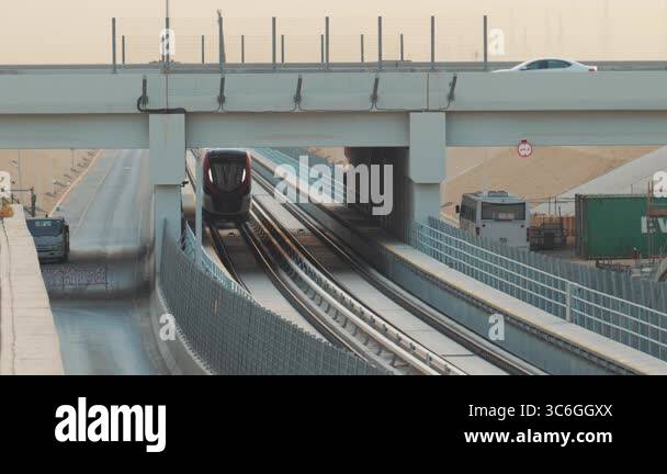 A metro train rides to a modern station in the city of Riyadh. An ...