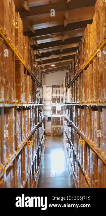 A large warehouse, with high racks, full of goods. storehouse in the ...