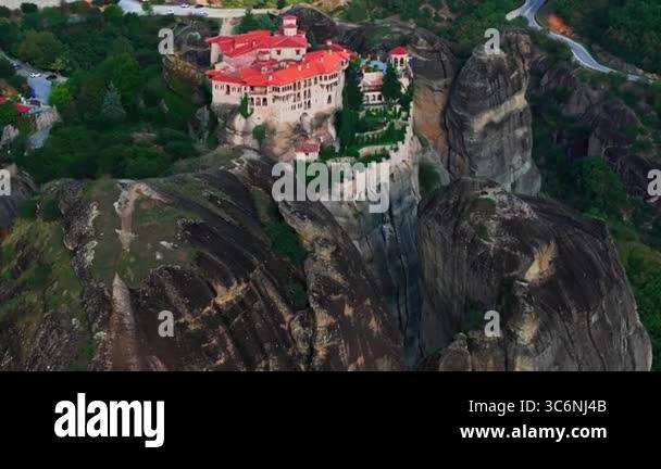 Captivating views of Meteora, Greece, showcase a stunning monastery perched atop a steep rock ...