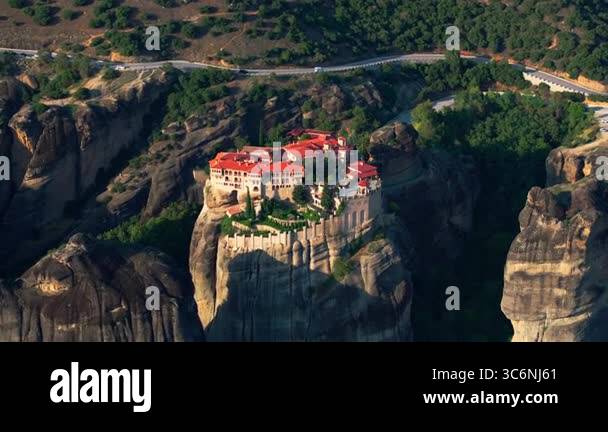 Warm sunlight bathing a monastery atop a dramatic rock formation ...