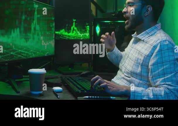 Tired sleepy Indian Arabian man worker typing keyboard computer late night home office male guy ...