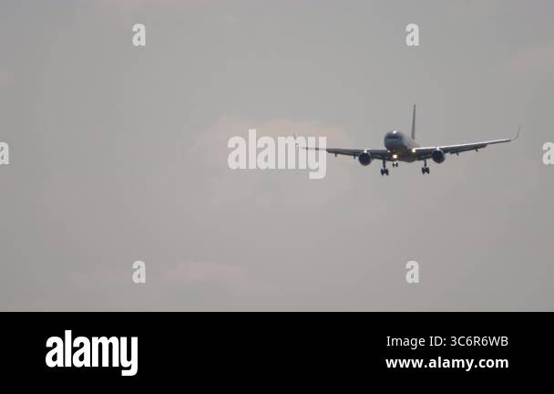Airplane approaching landing, front view. Jet plane descending ...