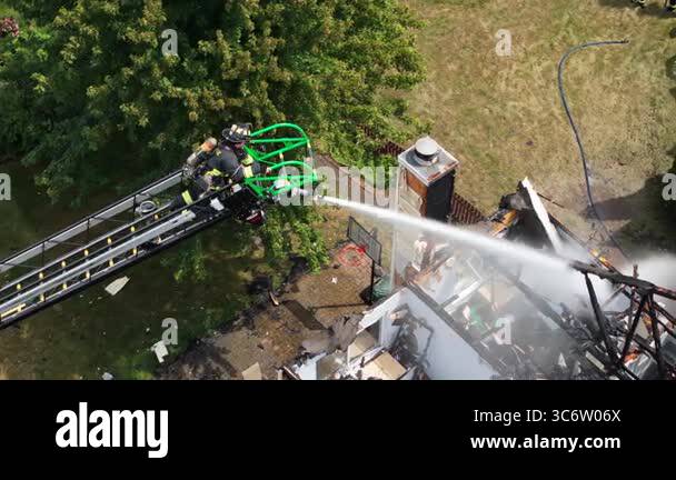 The firemen is putting , spraying a water with high pressure on burned ...