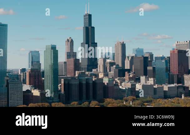 Scenic drone footage of downtown Chicago with fall colors under a sunny ...