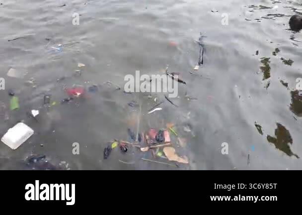 Garbage in the river, floating garbage causes water pollution. Garbage ...