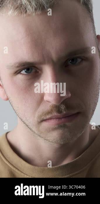 Portrait of a thoughtful and serious man looking directly at the camera ...