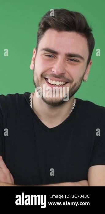 Portrait of a relaxed and positive man laughing joyfully on a green ...