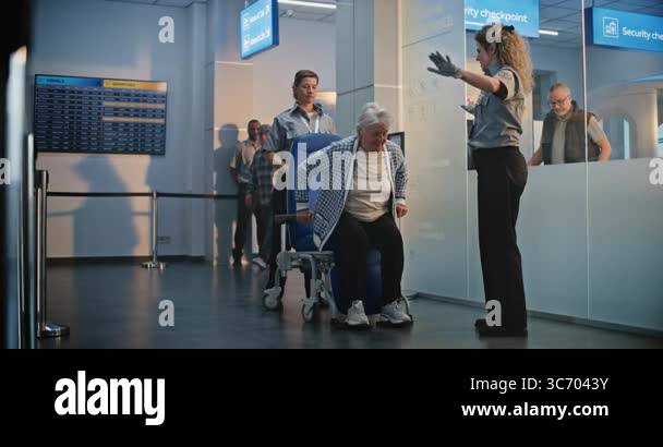 Security Checkpoint: Female TSA Officer Checking Elderly Woman Getting ...